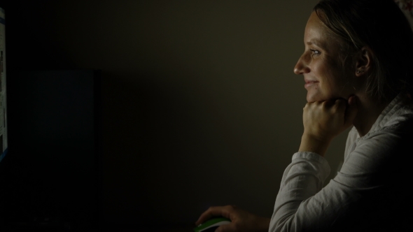 Face of a Woman Sitting in the Dark in Front of a Computer Monitor ...