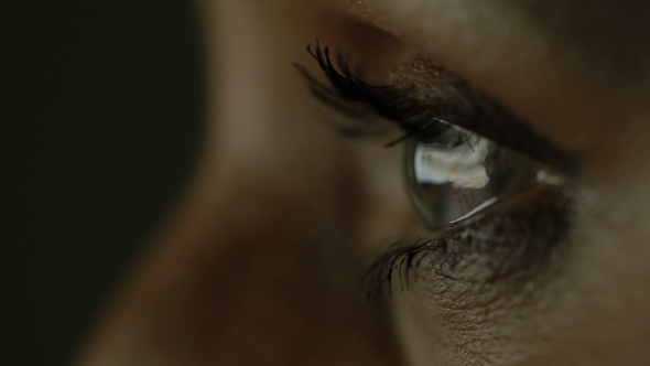Eye of a Woman Reflecting Pictures and Internet Pages., Stock Footage