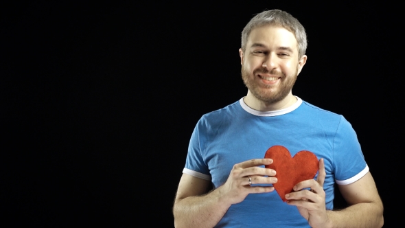 Happy Man in Blue Tshirt Holds One Red Heart Shape, Stock Footage ...