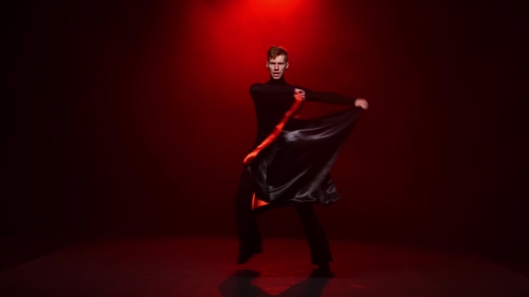Red Background. Man Is Dancing Solo with Red Black Cloth, Stock Footage