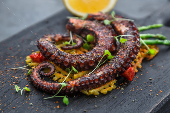 grilled Octopus appetizer with small potatoes, close view Stock Photo ...