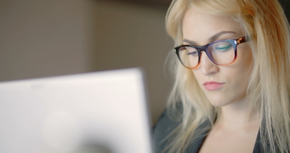 Businesswoman Wearing Eyeglasses While Using Laptop In Office, Stock ...