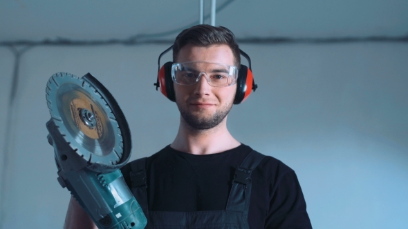 Smiling Construction Worker with Angle Grinder, Stock Footage | VideoHive