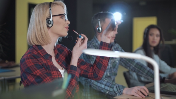 Woman Applying Lipstick in Call Center, Stock Footage | VideoHive