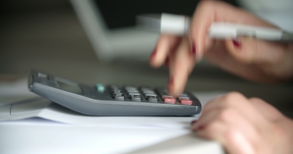 Businesswoman Using a Calculator in Office, Stock Footage | VideoHive