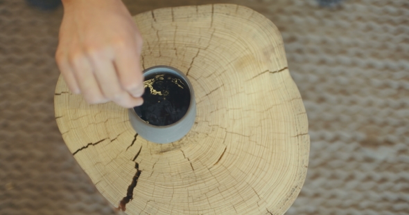 Person Stirring Drink In Cup On Tree Stump, Stock Footage | VideoHive