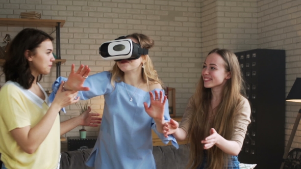 Three Young Female Friends Have Fun Together Using VR Device Actively ...