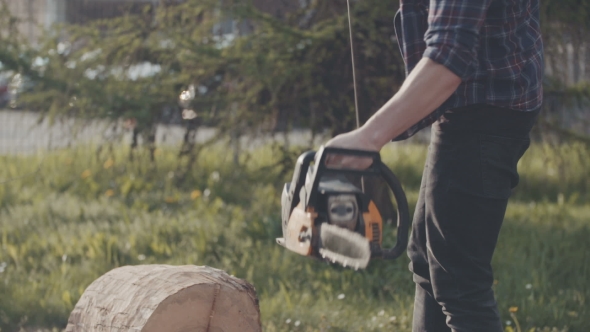 Young Man Cutting Wood With Chainsaw In Yard, Stock Footage | VideoHive