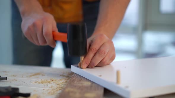 Man Clogging Wooden Dowel Using Mallet, Stock Footage | VideoHive