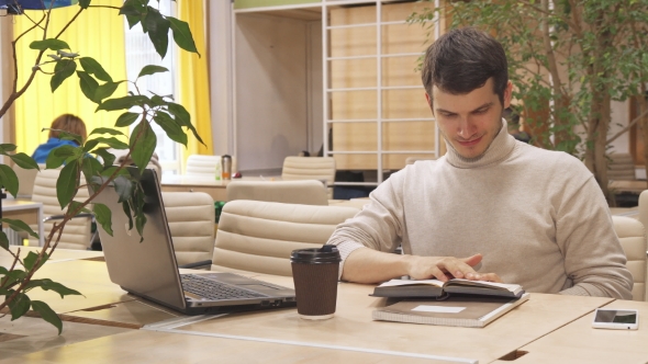 Man Reads the Book at the Working Hub, Stock Footage | VideoHive