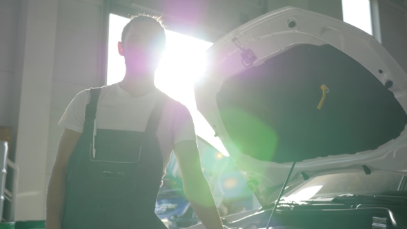 Portrait Master on Service Station, Machine Mechanic in Backlight Near ...