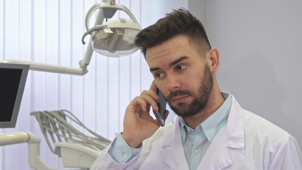 Dentist Talks on the Phone at the Office, Stock Footage | VideoHive