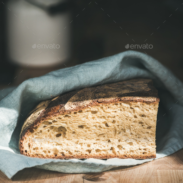 Rustic French rye bread loaf on wooden board, square crop Stock Photo ...