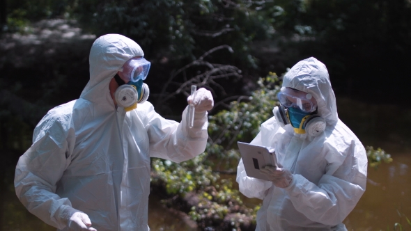 Two Ecological Workers in Biohazard Suits Sampling Water, Stock Footage