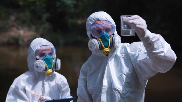 Two Ecological Workers in Biohazard Suits Sampling Water, Stock Footage