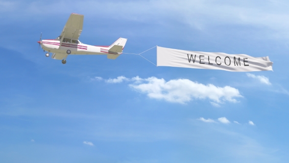 Small Propeller Airplane Towing Banner with WELCOME Caption in the Sky ...