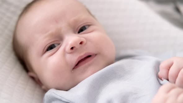 Dissatisfied Crying Upset Sad Newborn Baby Boy Lying in Nursery Cocoon ...