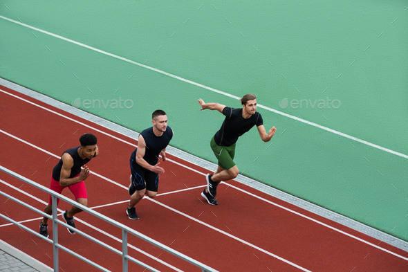Concentrated multiethnic athlete group run Stock Photo by vadymvdrobot
