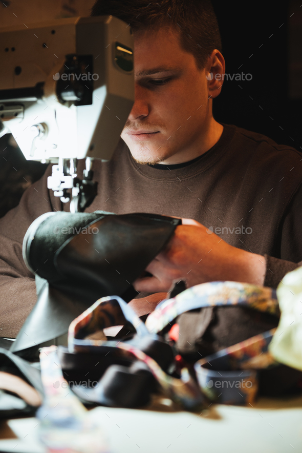 Concentrated man shoemaker at footwear workshop. Stock Photo by ...
