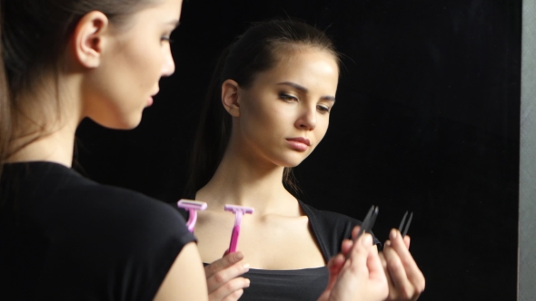Girl Is Holding a Shaving Machine and She Is Upset with Tweezers. Black ...