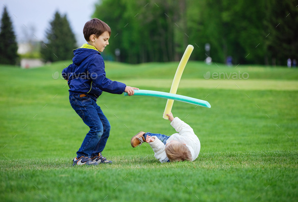 Preschool boys fighting with toy swords Stock Photo by photobac | PhotoDune