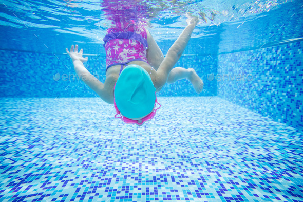 Little girl diving in swimming pool Stock Photo by photobac | PhotoDune