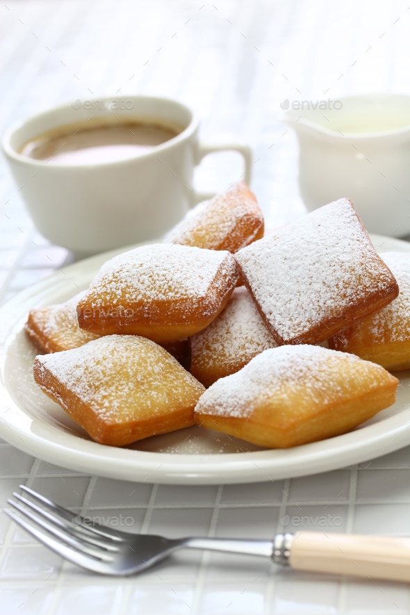 homemade new orleans beignet and a cup of coffee Stock Photo by motghnit