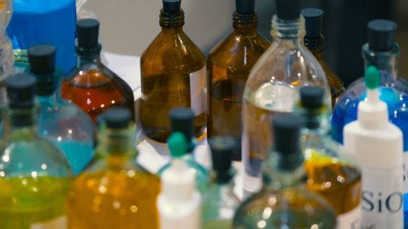 Chemical Laboratory with Multicolored Bottles with Reagents on the ...