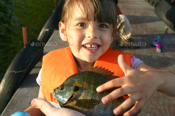 Happy Little Girl Shows Off the First Fish She Caught Stock Photo by ...