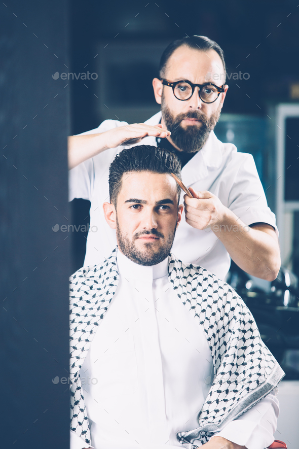 Barber combing stylish man Stock Photo by Click_and_Photo | PhotoDune