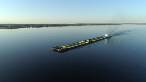 A View From Above on a Barge That Goes on Smooth Water with a Load ...