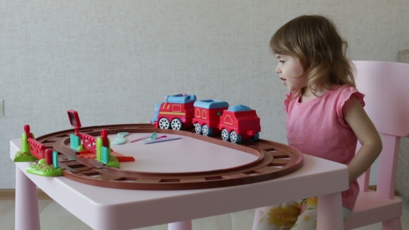 Girl Playing with Her Toy Trains on Track, Stock Footage | VideoHive