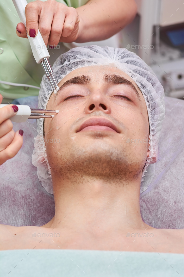 Microcurrent face therapy, young man Stock Photo by stockfilmstudio