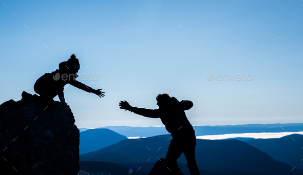 Couple in silhouettes helping each other for Sucess Stock Photo by aetb
