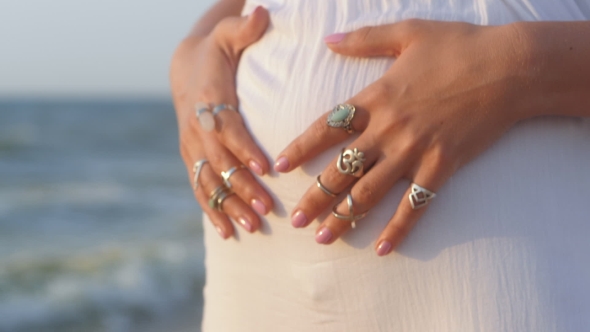 Pregnant Young Gypsy Woman with Boho Jewelry Touching Her Belly. Girl ...