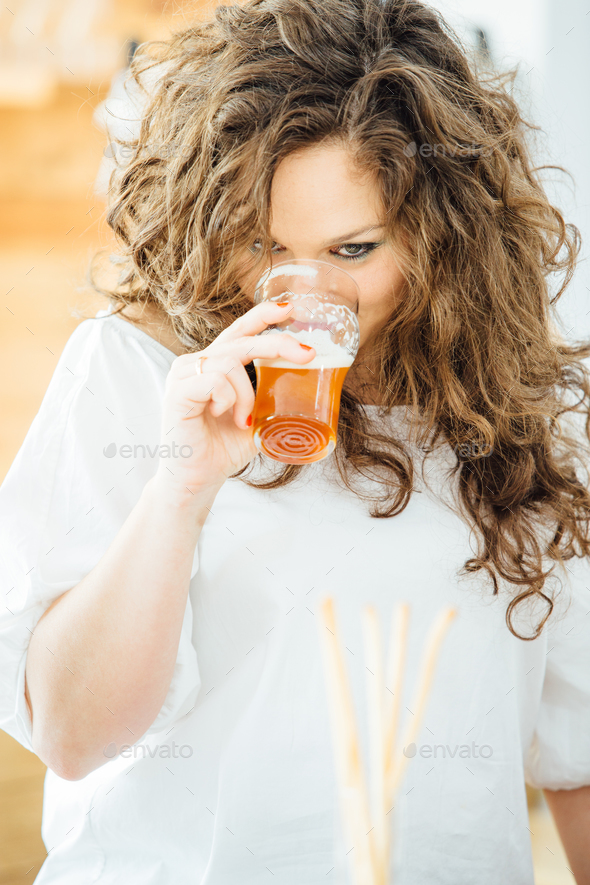 Woman drinking light craft beer Stock Photo by Click_and_Photo | PhotoDune