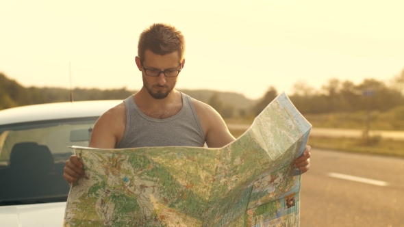 Man Reading Map on the Car's Hood, Stock Footage | VideoHive