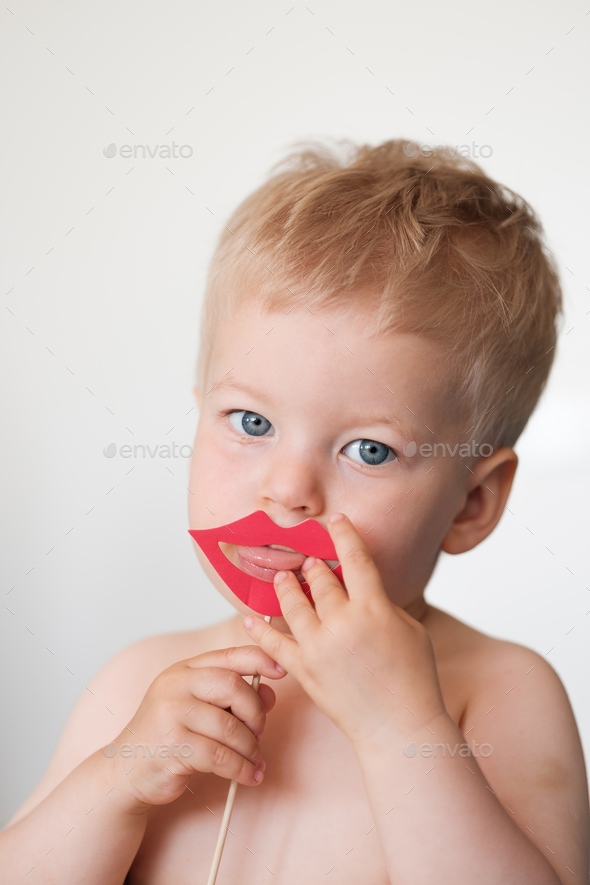 Baby boy with paper lips on a stick Stock Photo by haveseen | PhotoDune