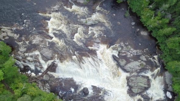 Rising Aerial Shot Looking Down at Raging Waterfall in a River, Stock ...