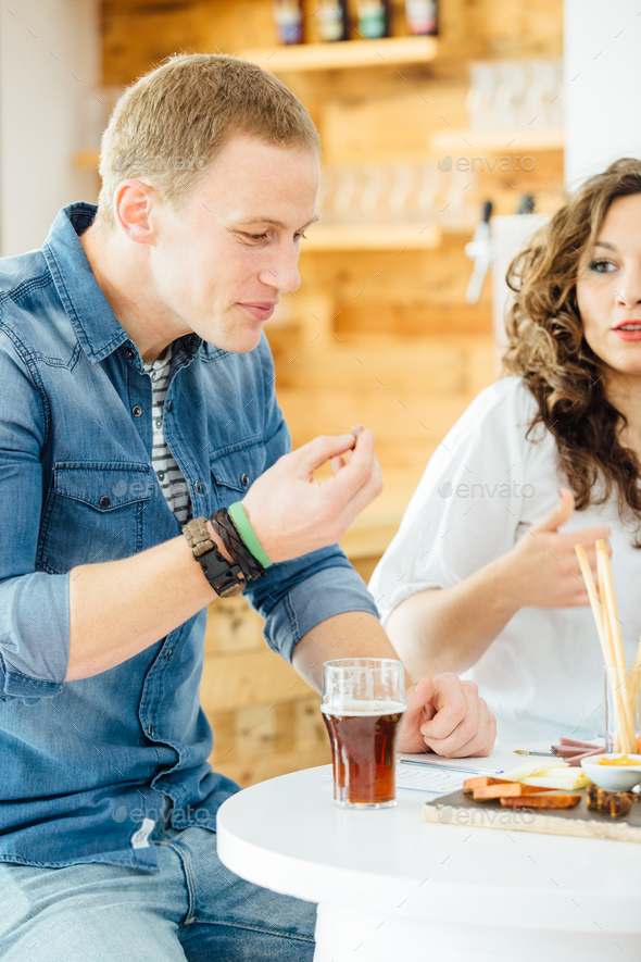 Man eating snack at table Stock Photo by Click_and_Photo | PhotoDune