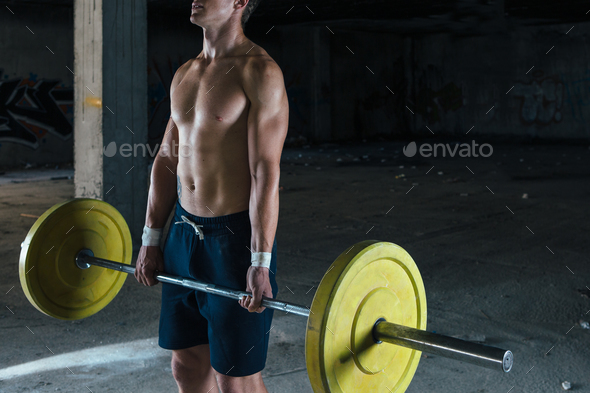Side view of faceless man lifting barbell Stock Photo by Click_and_Photo