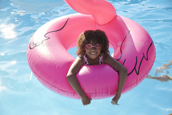 Girl Having Fun With Inflatable In Outdoor Swimming Pool Stock Photo by ...