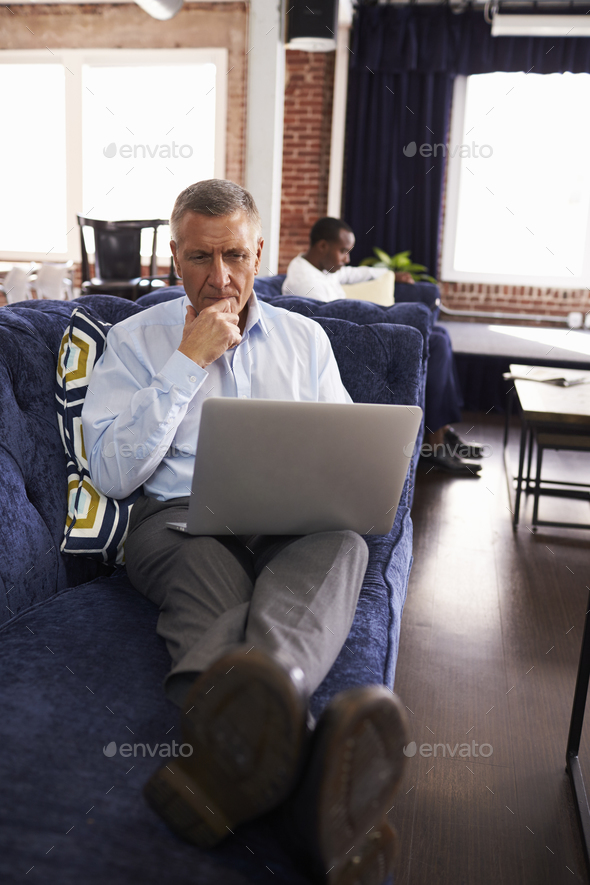 Businessmen Working On Sofas In Relaxation Area Of Office Stock Photo ...