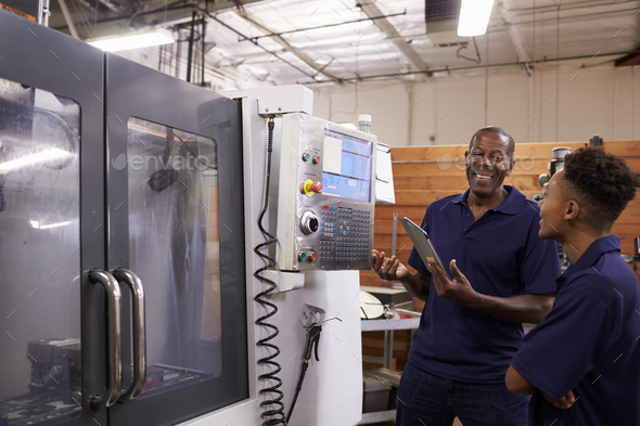 Engineer Training Young Male Apprentice On CNC Machine Stock Photo by ...