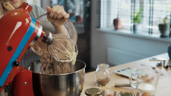 Young Attractive Woman Adding Ingredients in the Bowl and Turning on ...