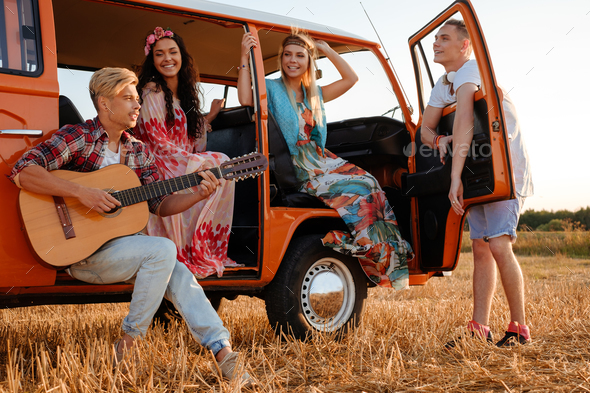 Hippie friends with guitar on a road trip Stock Photo by Nejron | PhotoDune