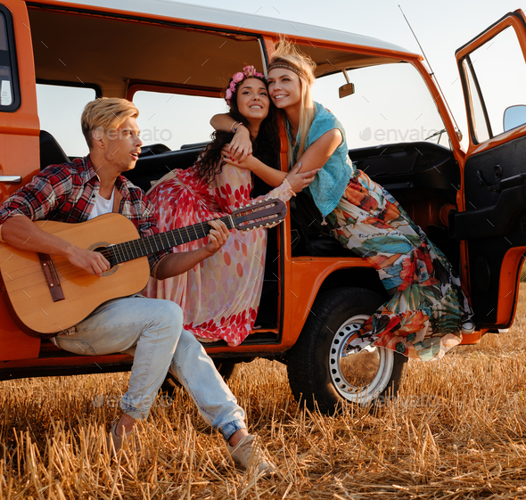 Hippie friends with guitar on a road trip Stock Photo by Nejron | PhotoDune