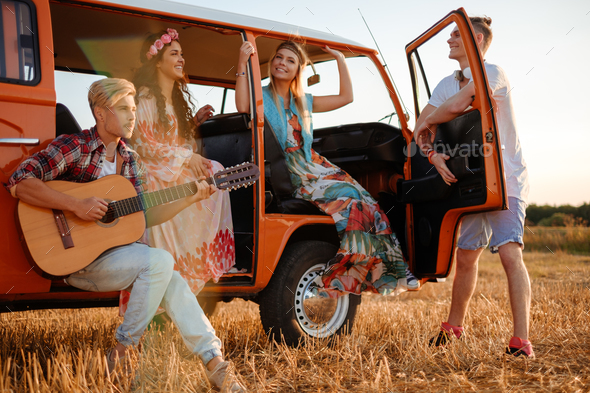 Hippie friends with guitar on a road trip Stock Photo by Nejron | PhotoDune