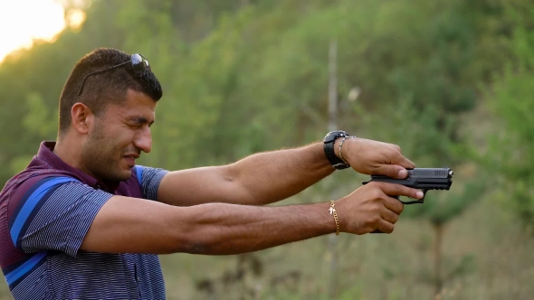 Young Arab Man Is Shooting From a Gun, Stock Footage | VideoHive