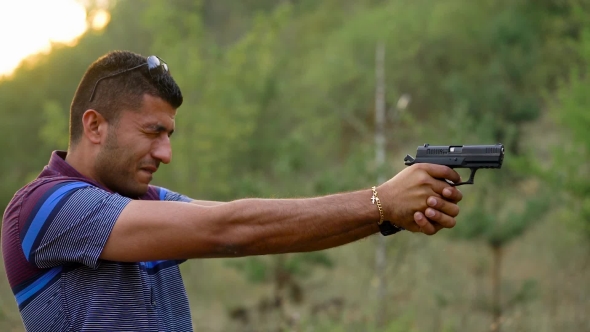 Young Arab Man Is Shooting From a Gun, Stock Footage | VideoHive
